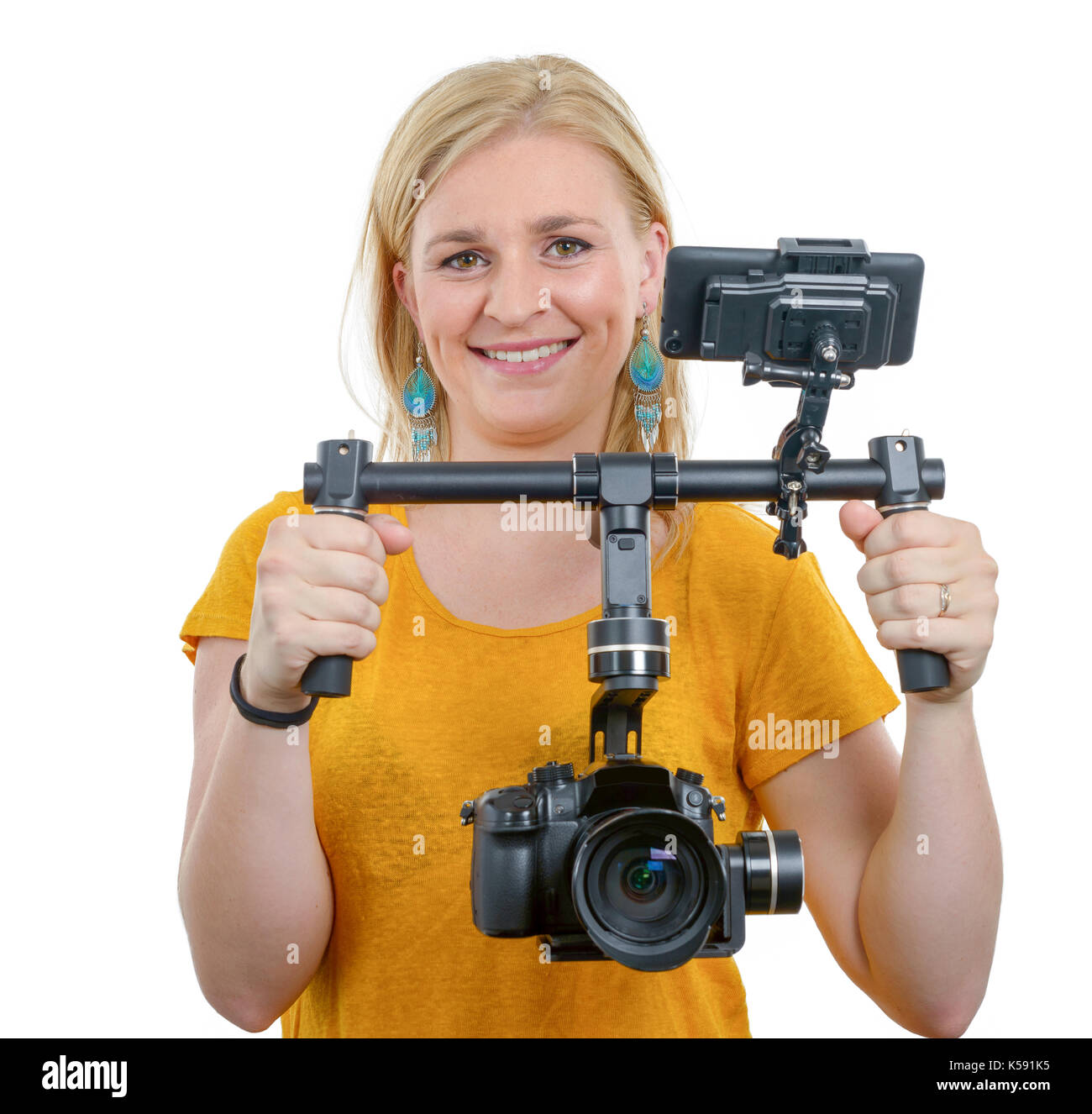 young woman videographer using steady cam Stock Photo - Alamy