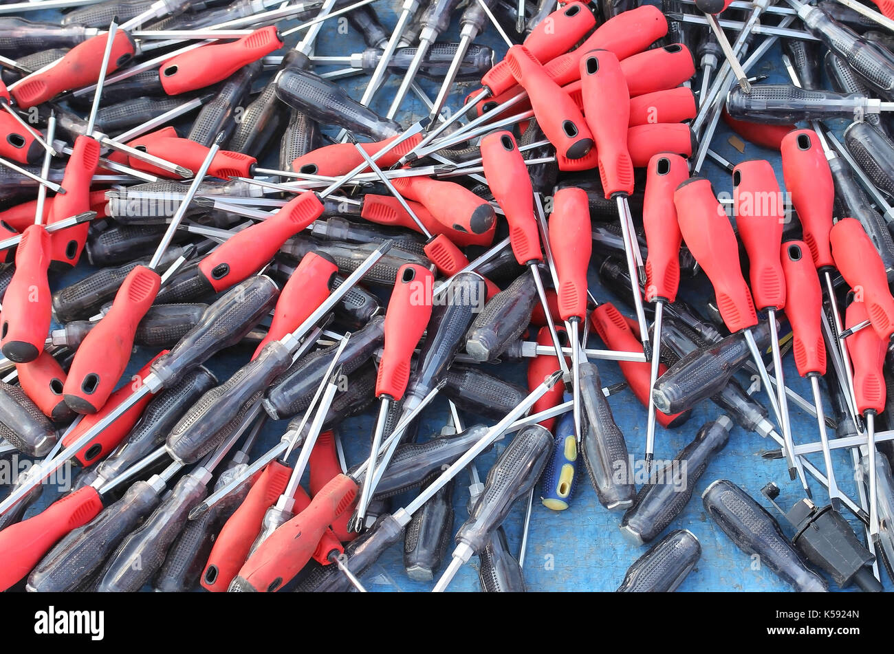 Old screw drivers pile with rusty metal parts Stock Photo - Alamy