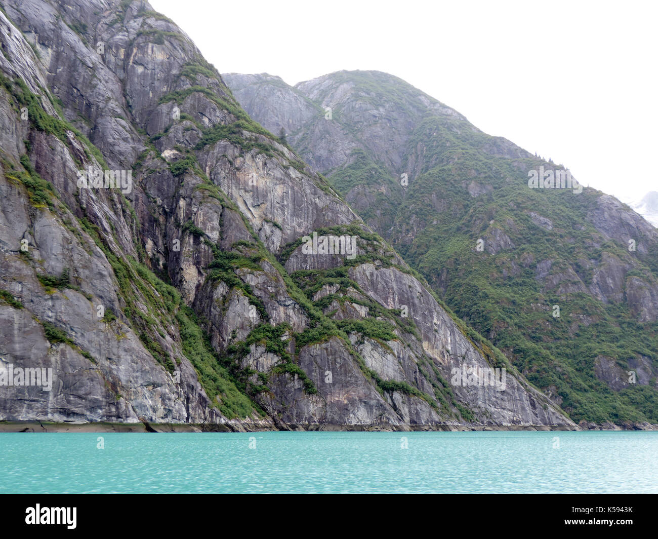 BEAUTIFUL BLUE GLACIAL WATER AND CLIFFS, ALASKA Stock Photo - Alamy