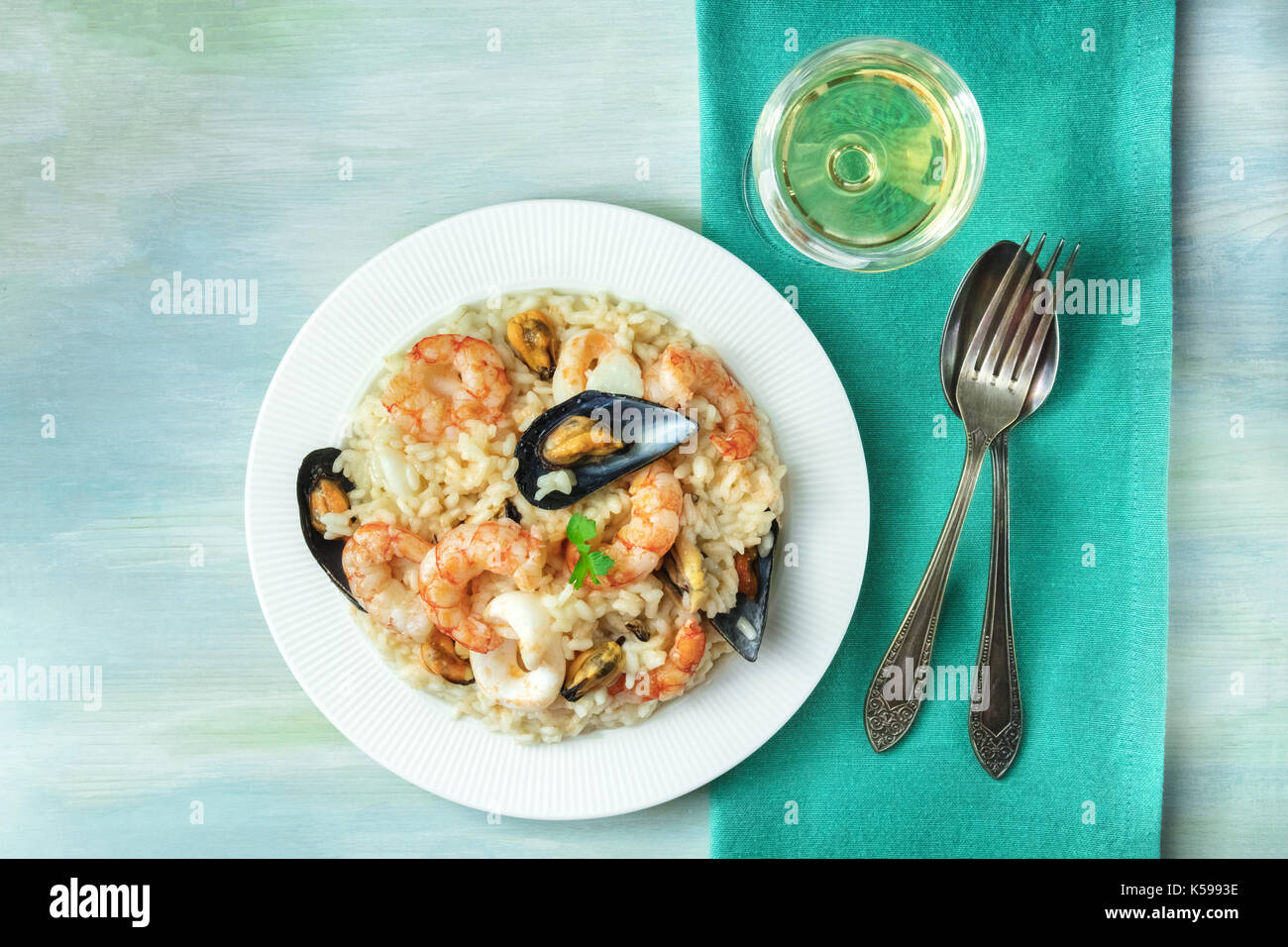 Seafood risotto plate on teal textures with copyspace Stock Photo - Alamy