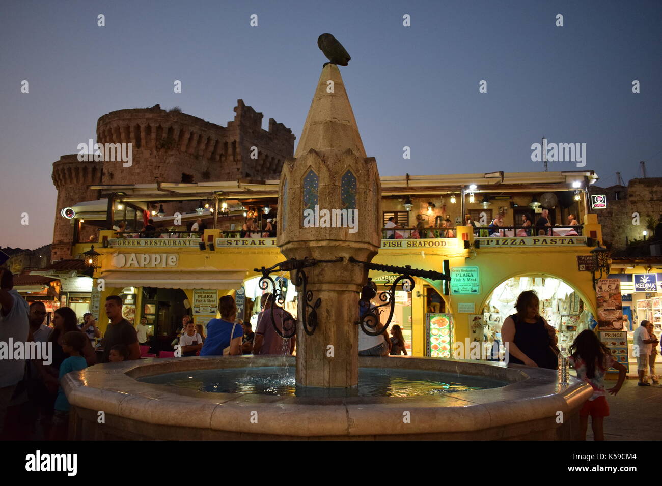 Rhodes old town fountain by night Stock Photo - Alamy