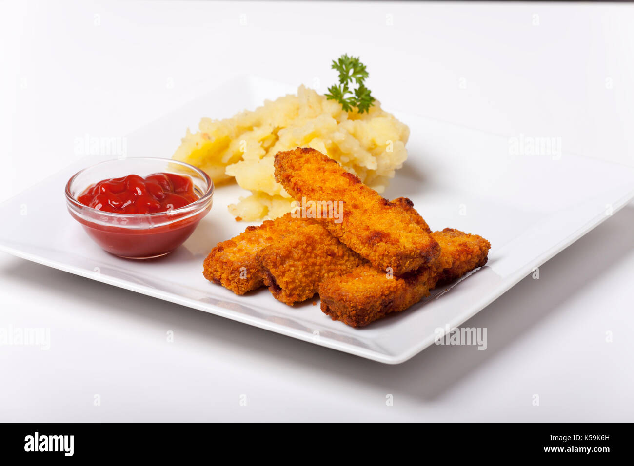 fish fingers with potato salad Stock Photo - Alamy