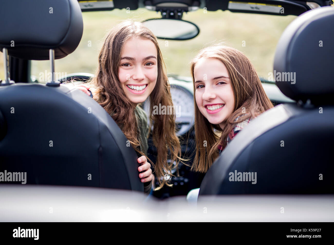 Young women driving. Teenage friends driving a car Stock Photo - Alamy