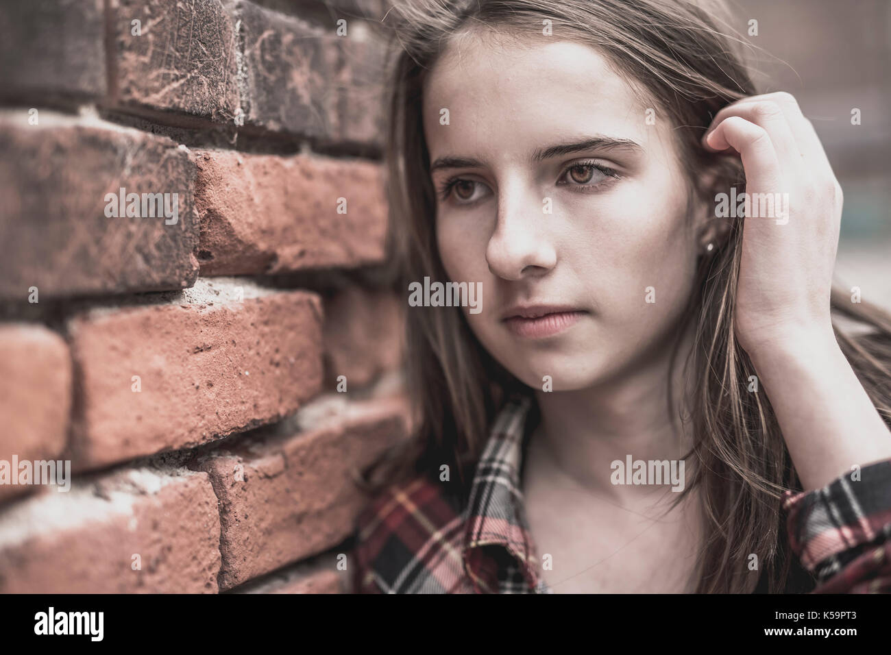 Teenage girl against a brick wall Stock Photo - Alamy