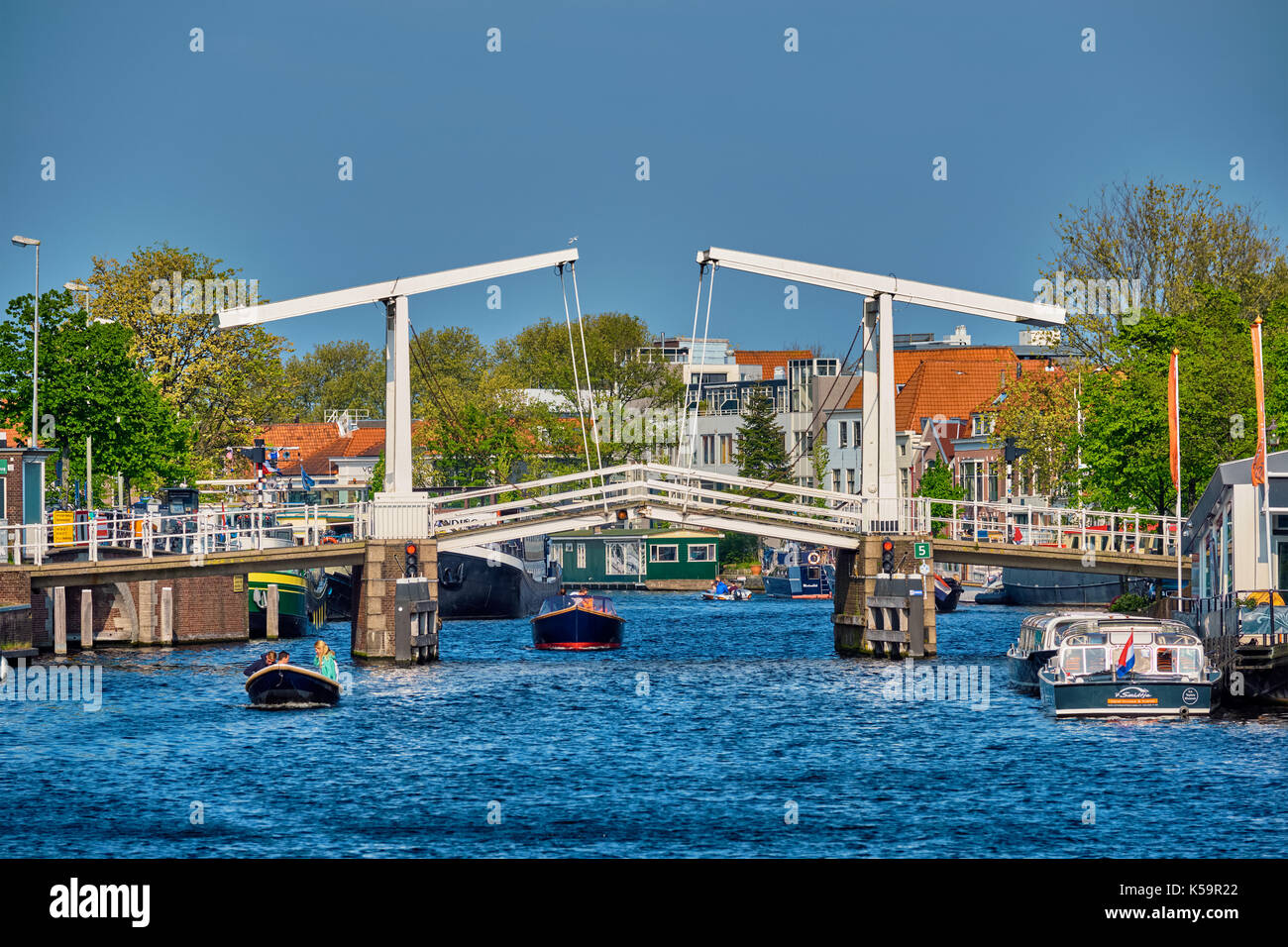 Boat passing under Gravestenenbrug bridge in Haarlem, Netherland Stock ...