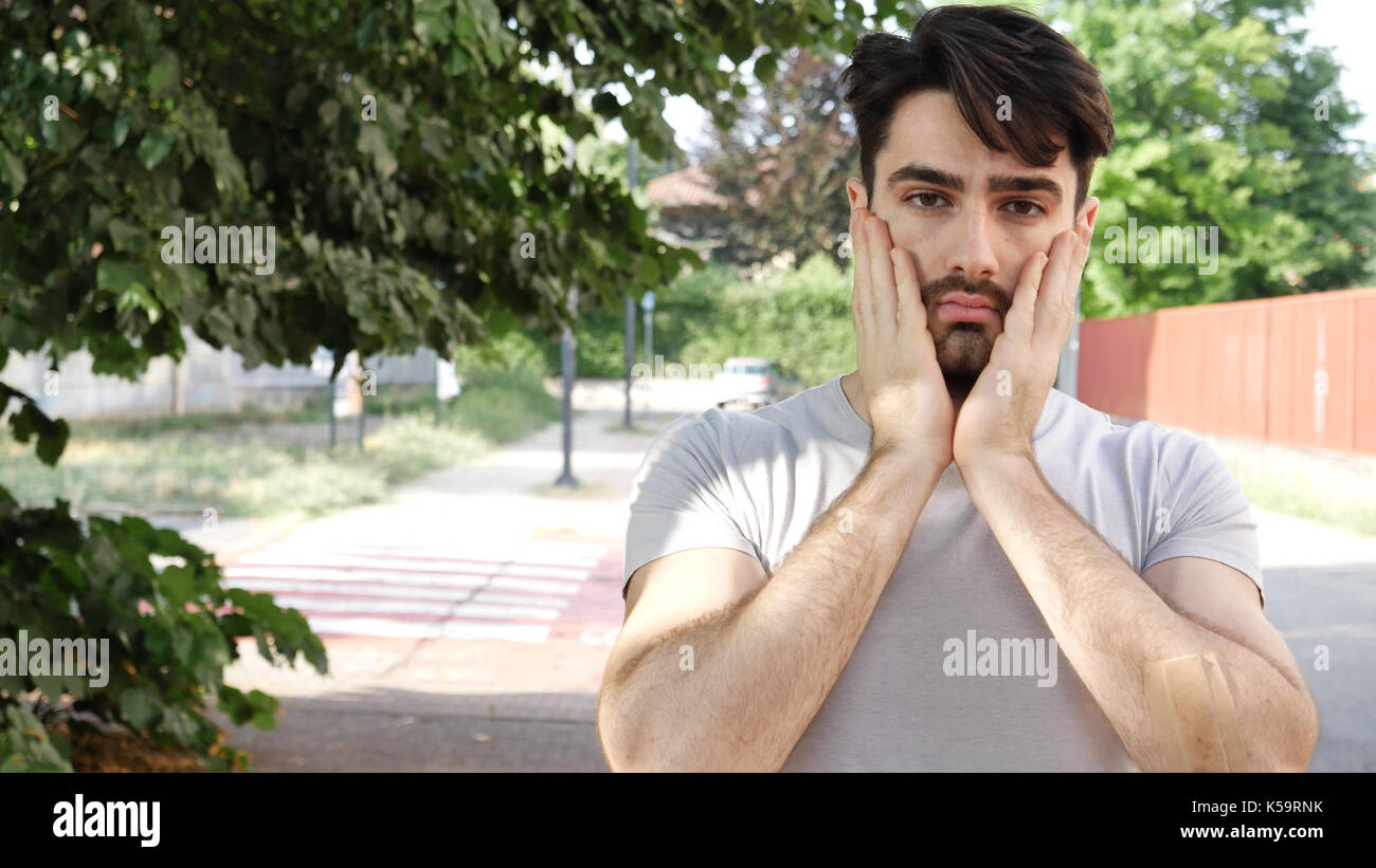 Tired man posing at street Stock Photo - Alamy