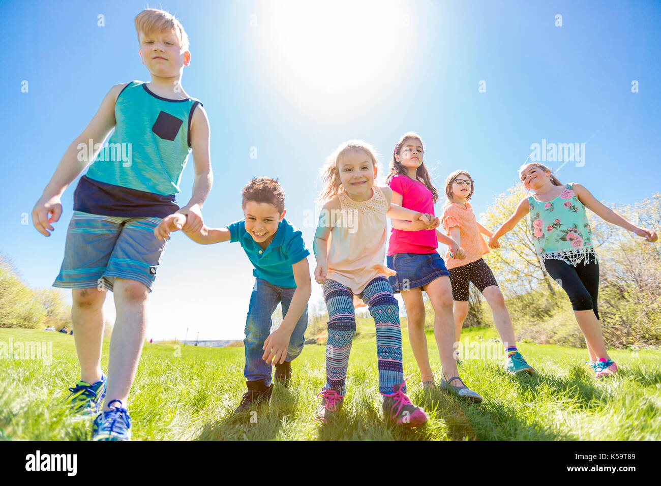 Group of child have fun on a field Stock Photo - Alamy