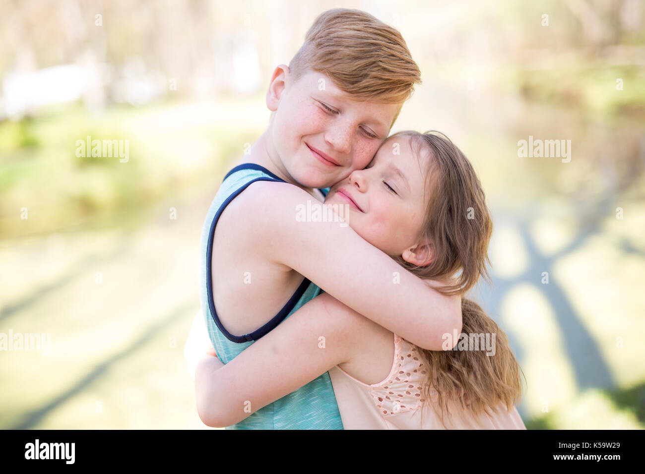 Portrait of a little girl on a yellow background. with his brother ...