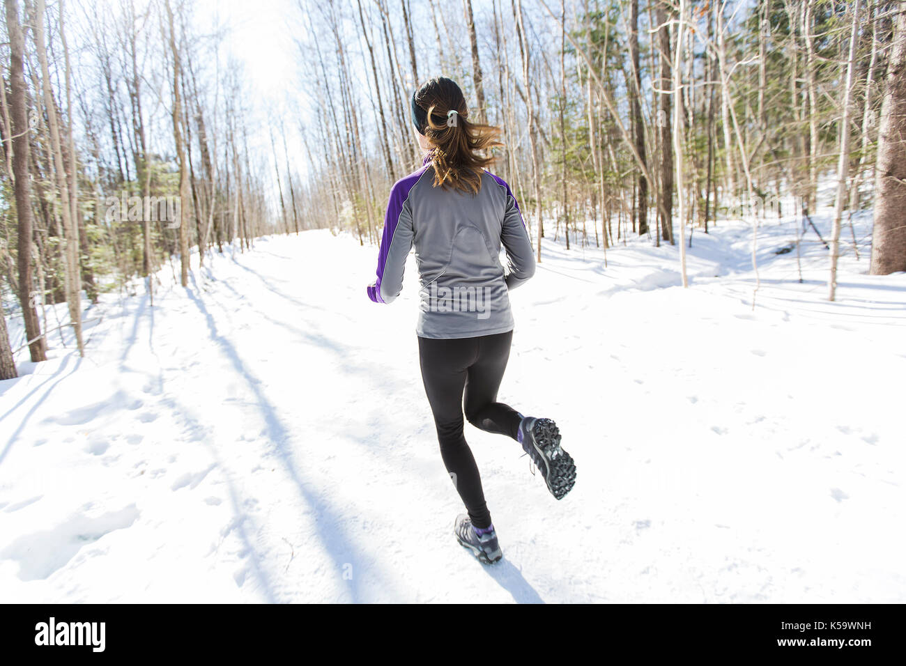 Winter running exercise. Runner jogging in snow Stock Photo - Alamy