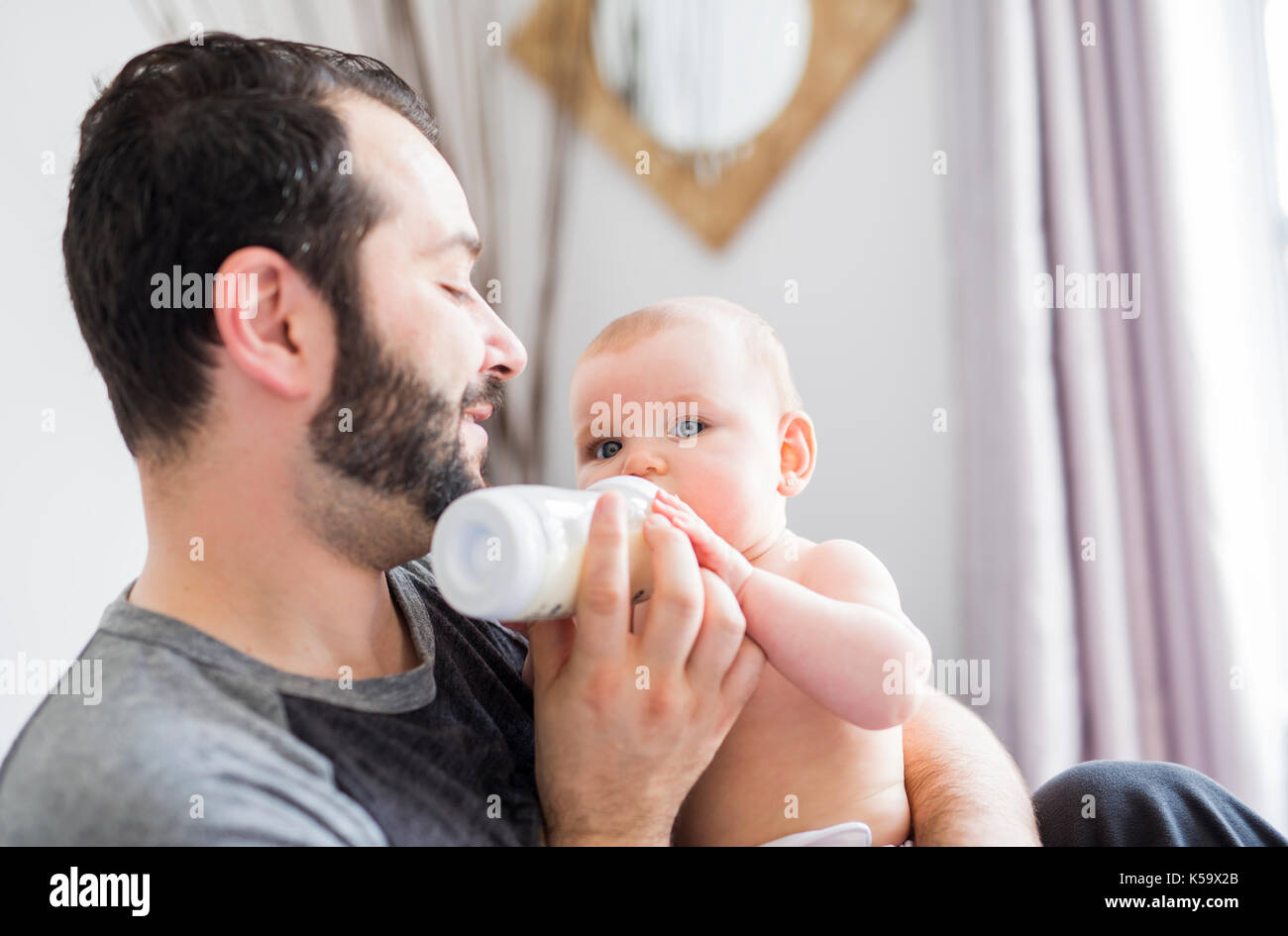 Innocent baby father feeding milk hi-res stock photography and images ...