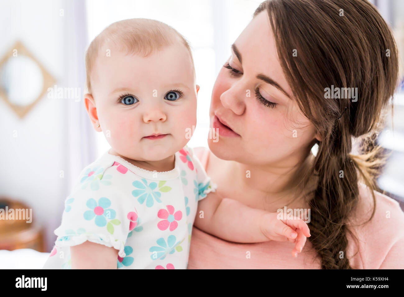 Mother and baby hugging at bedroom Stock Photo - Alamy