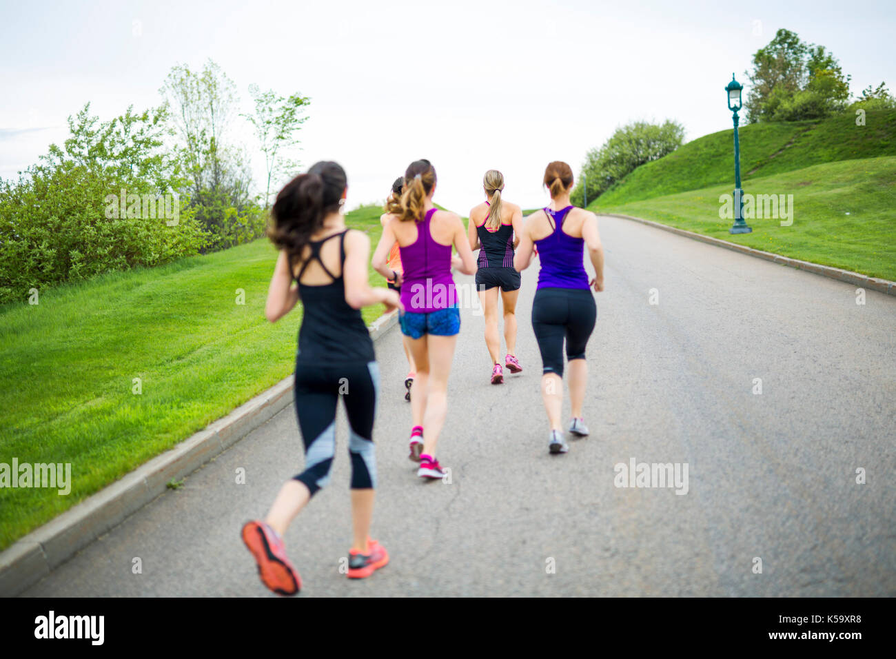 group of people enjoying in the fitness having fun running outside ...