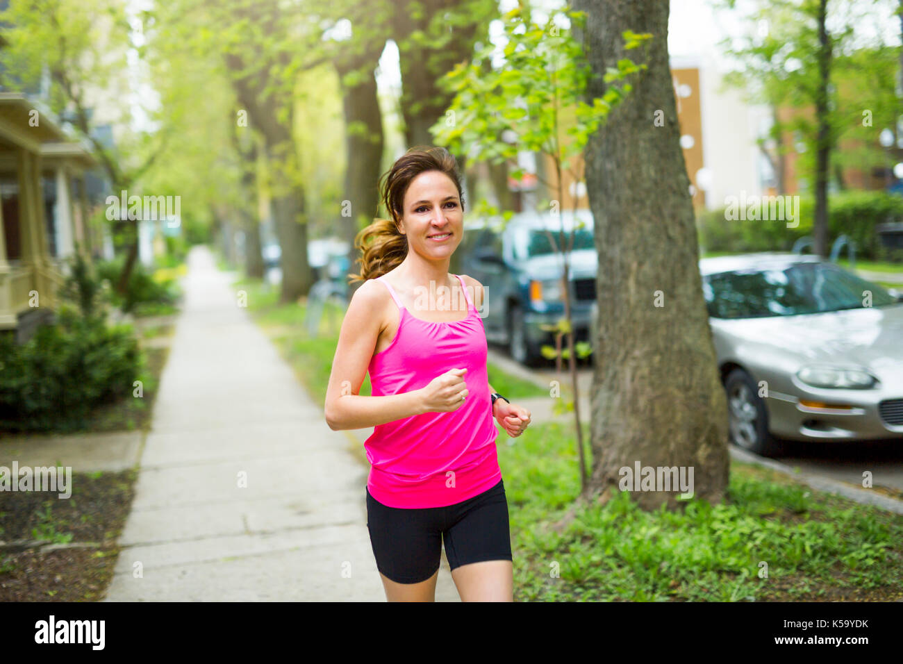 portrait of a woman jogging outdoors Stock Photo - Alamy