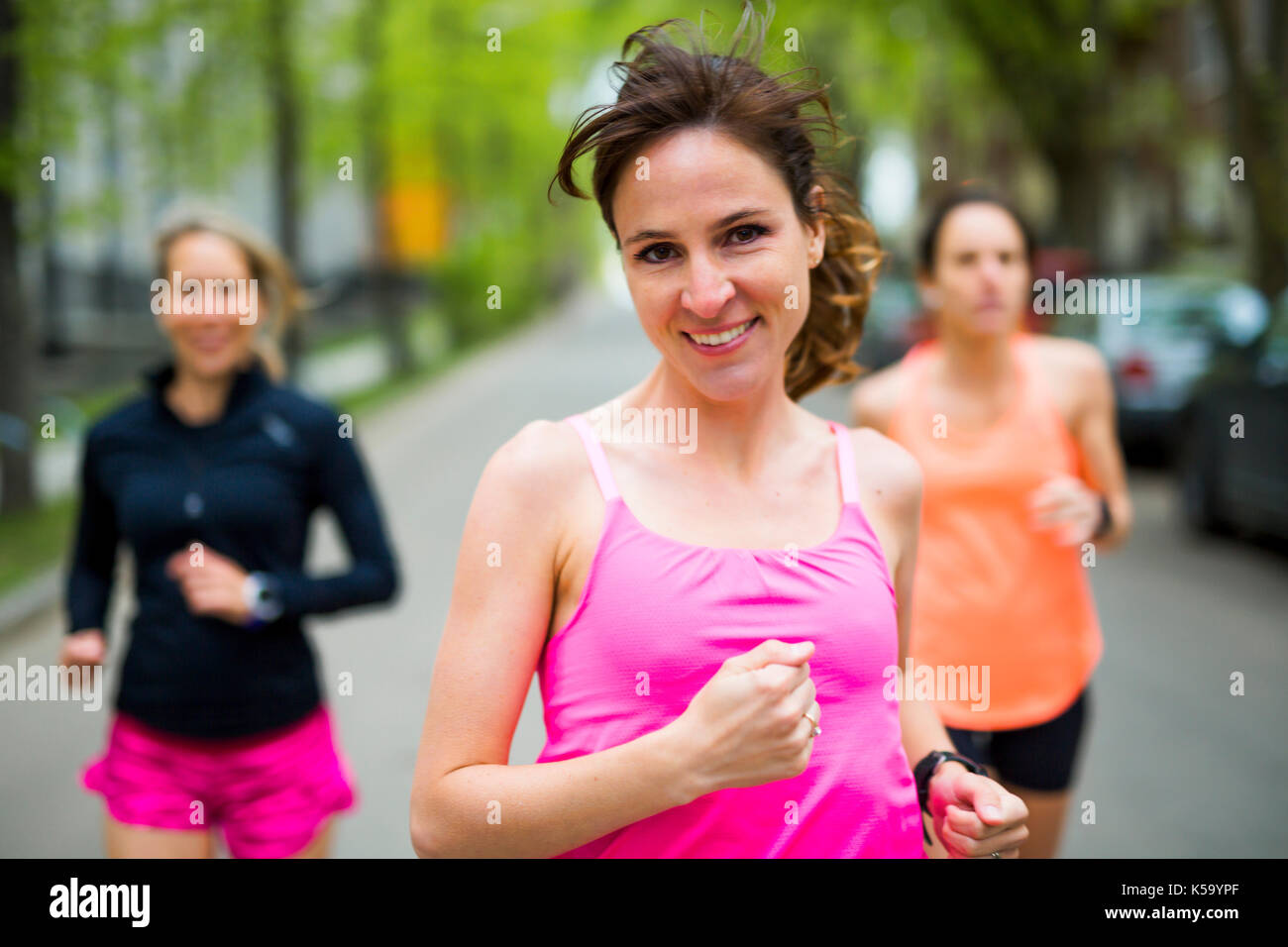 group of people enjoying in the fitness having fun running outside ...