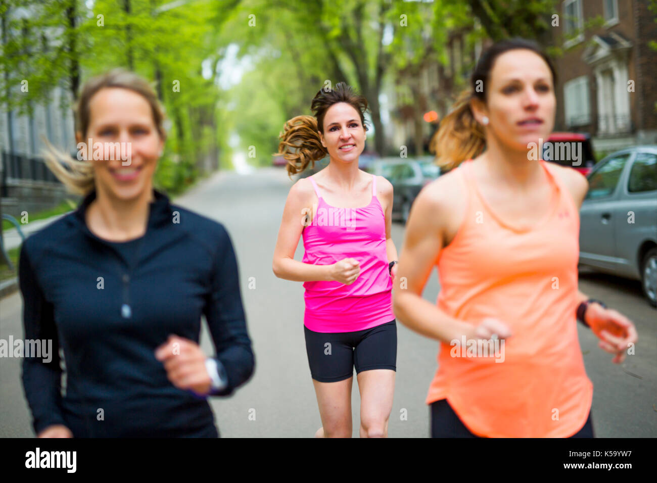 group of people enjoying in the fitness having fun running outside ...
