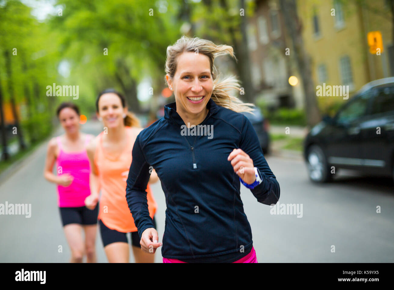 group of people enjoying in the fitness having fun running outside ...