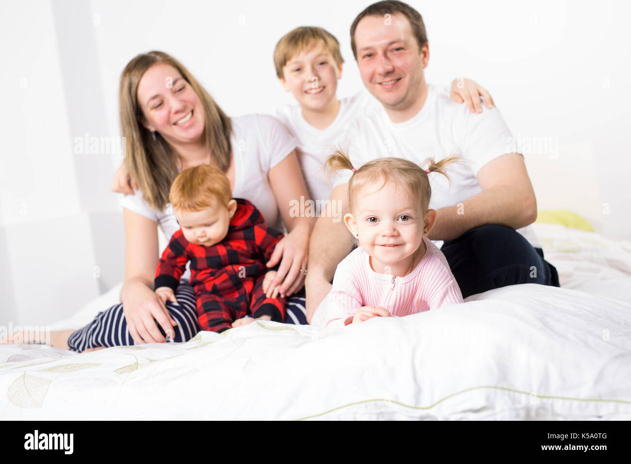 five member Young Family Having Fun In Bed Stock Photo - Alamy