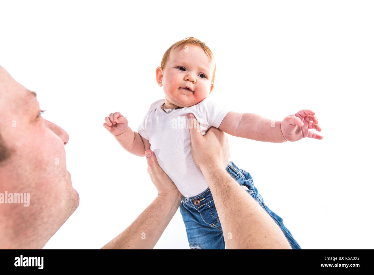 Men's hands hold the baby on a white background Stock Photo - Alamy
