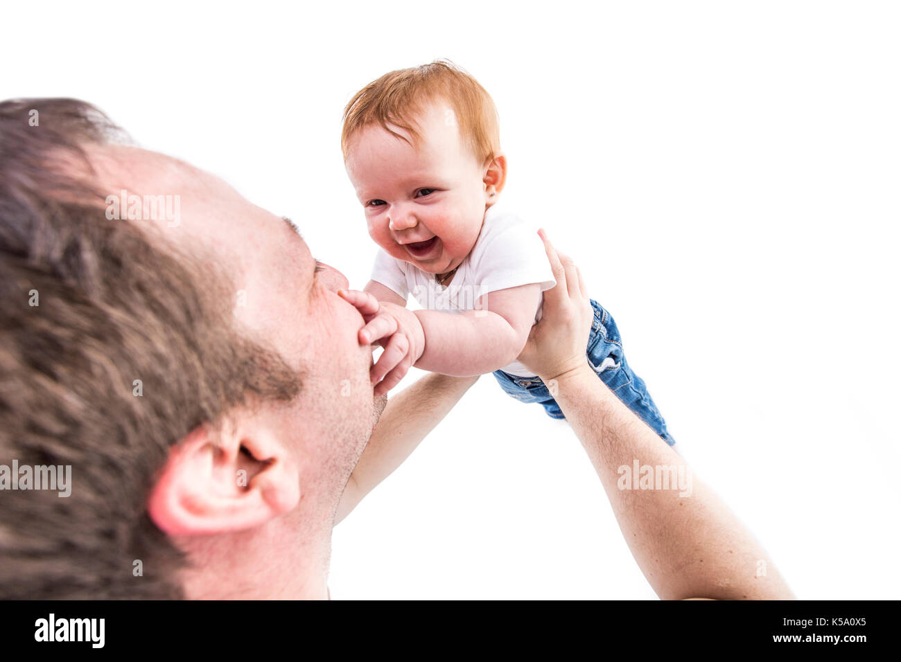 Men's hands hold the baby on a white background Stock Photo - Alamy