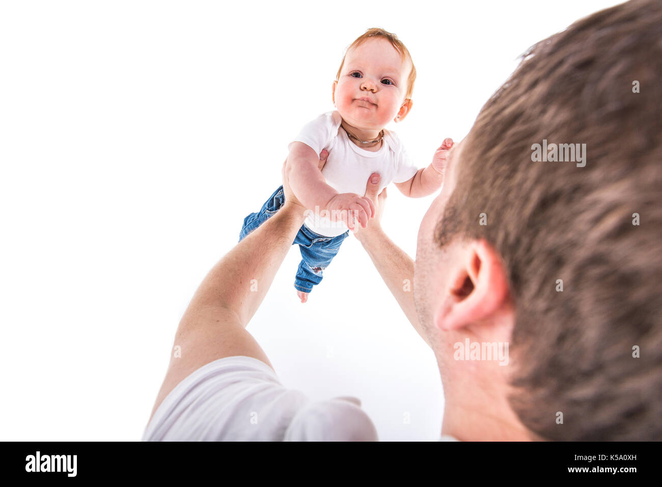 Men's hands hold the baby on a white background Stock Photo - Alamy