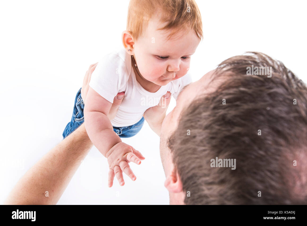 Men's hands hold the baby on a white background Stock Photo - Alamy