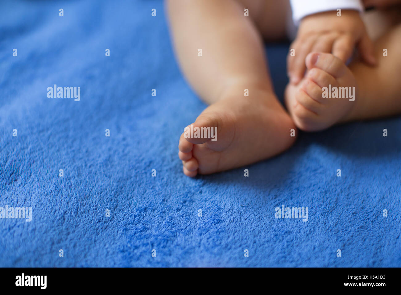 Baby legs on the bed Stock Photo - Alamy