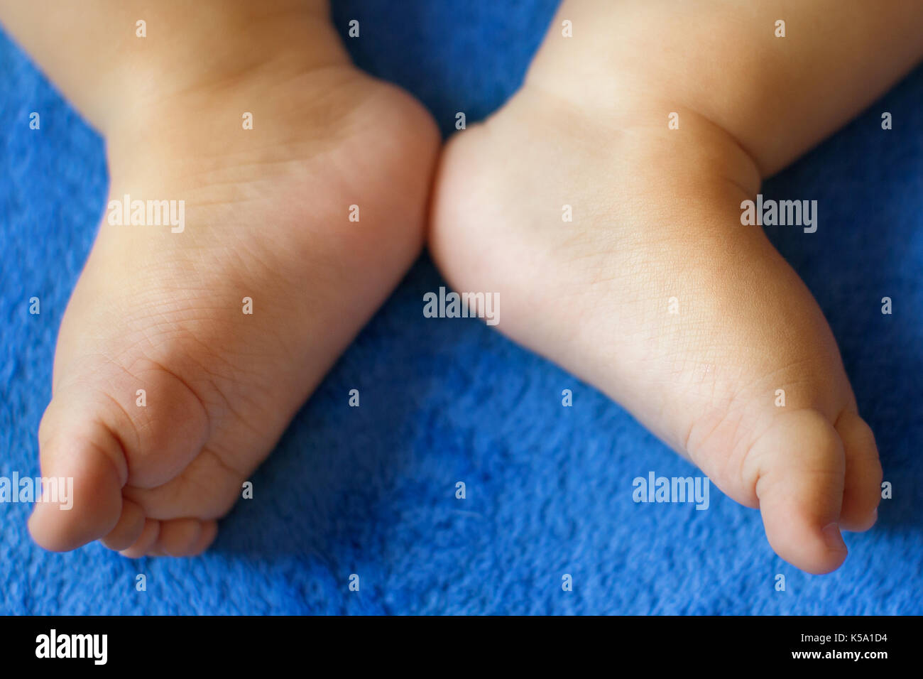 Baby legs on the bed Stock Photo - Alamy