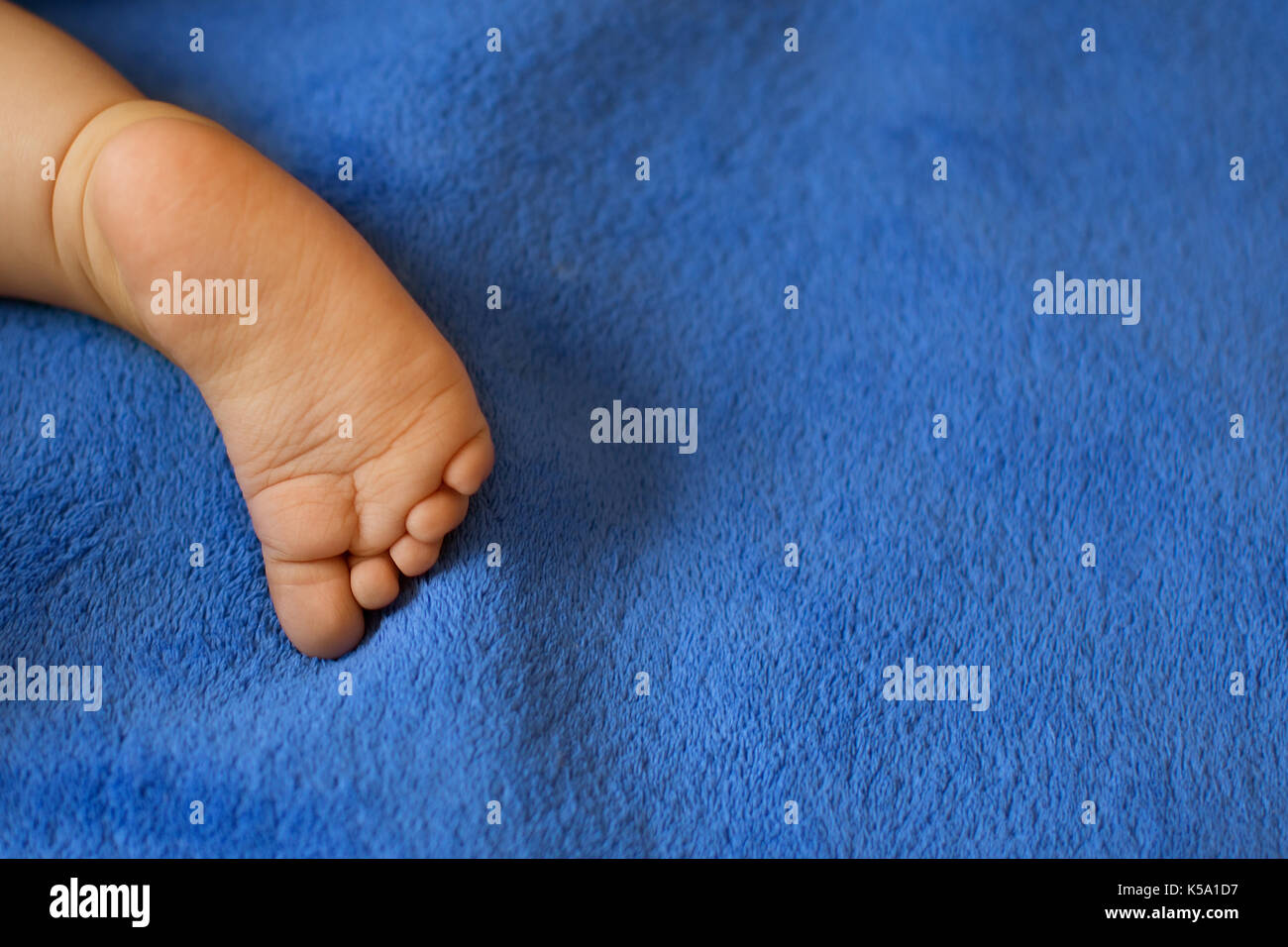 Baby legs on the bed Stock Photo - Alamy