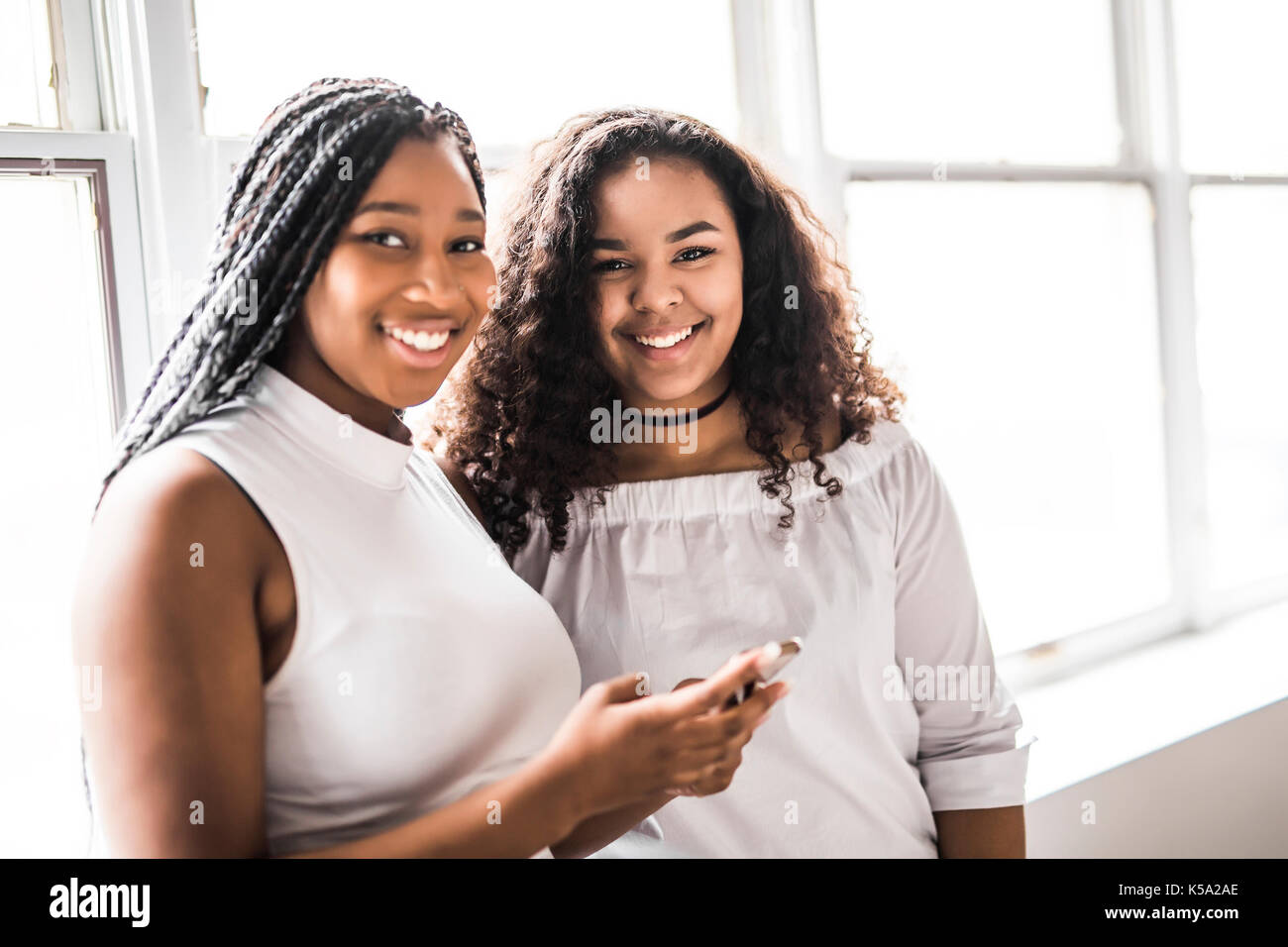 Two young afro girls having fun together Stock Photo - Alamy