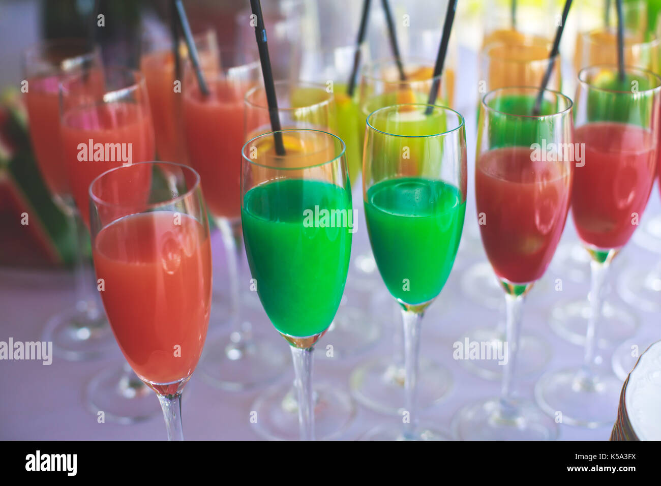 Beautiful line of different coloured alcohol cocktails on a open air ...