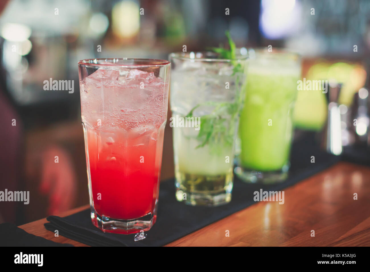Beautiful line of different coloured alcohol cocktails on a open air ...