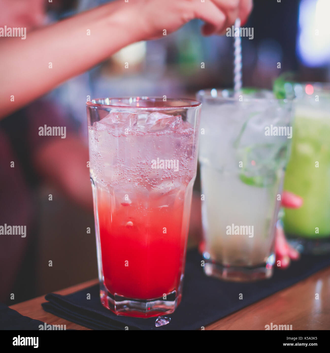 Beautiful line of different coloured alcohol cocktails on a open air ...