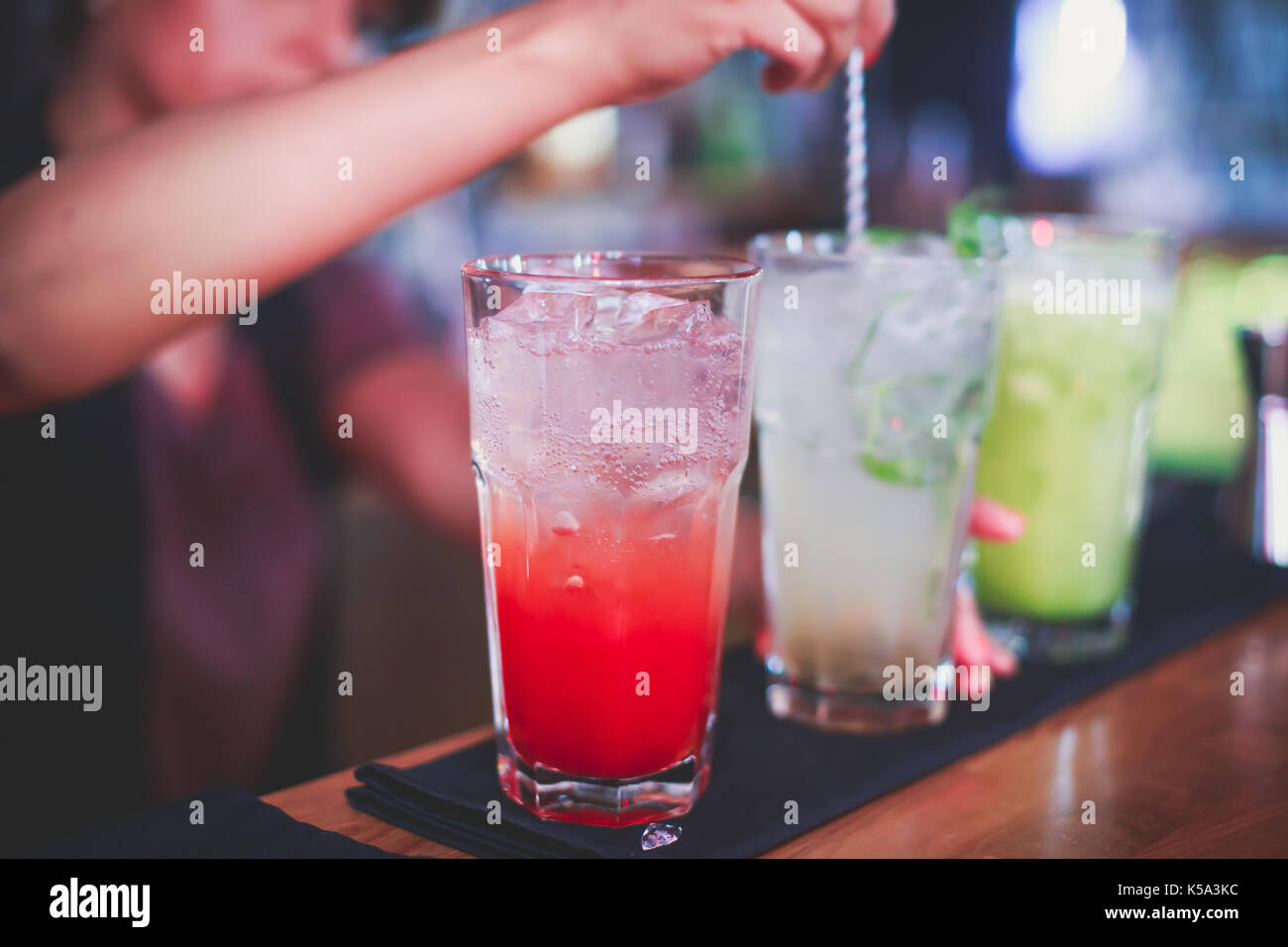 Beautiful line of different coloured alcohol cocktails on a open air ...