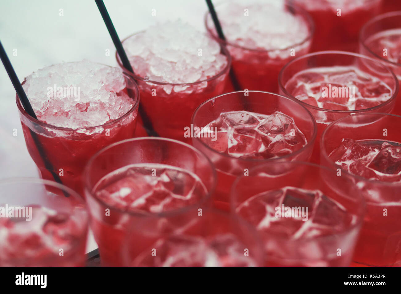 Beautiful line of different coloured alcohol cocktails on a open air ...