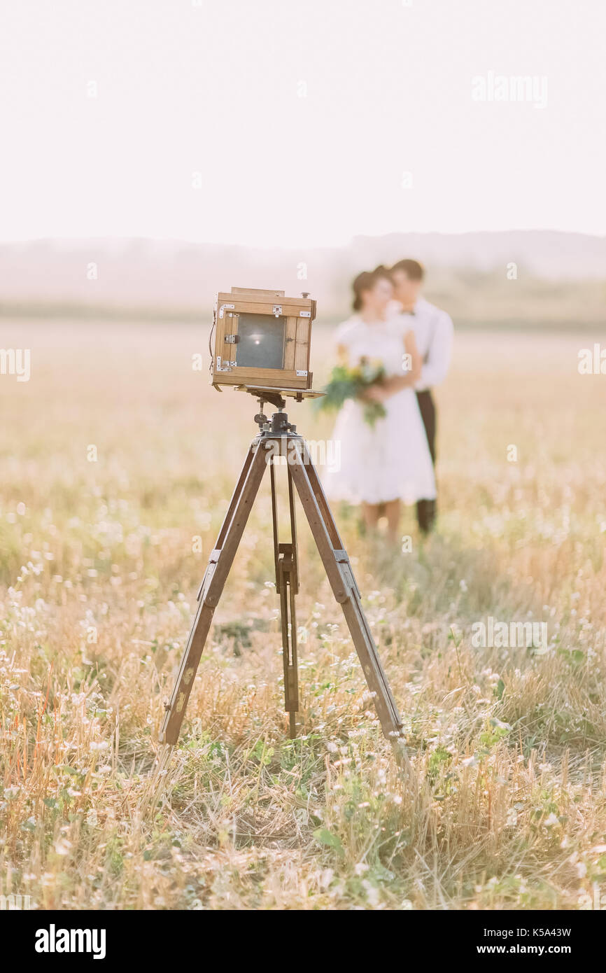 The view of the vintage camera in the front of the blurred hugging ...