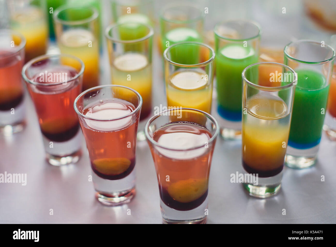 Beautiful line of different coloured cocktails on a open air party ...