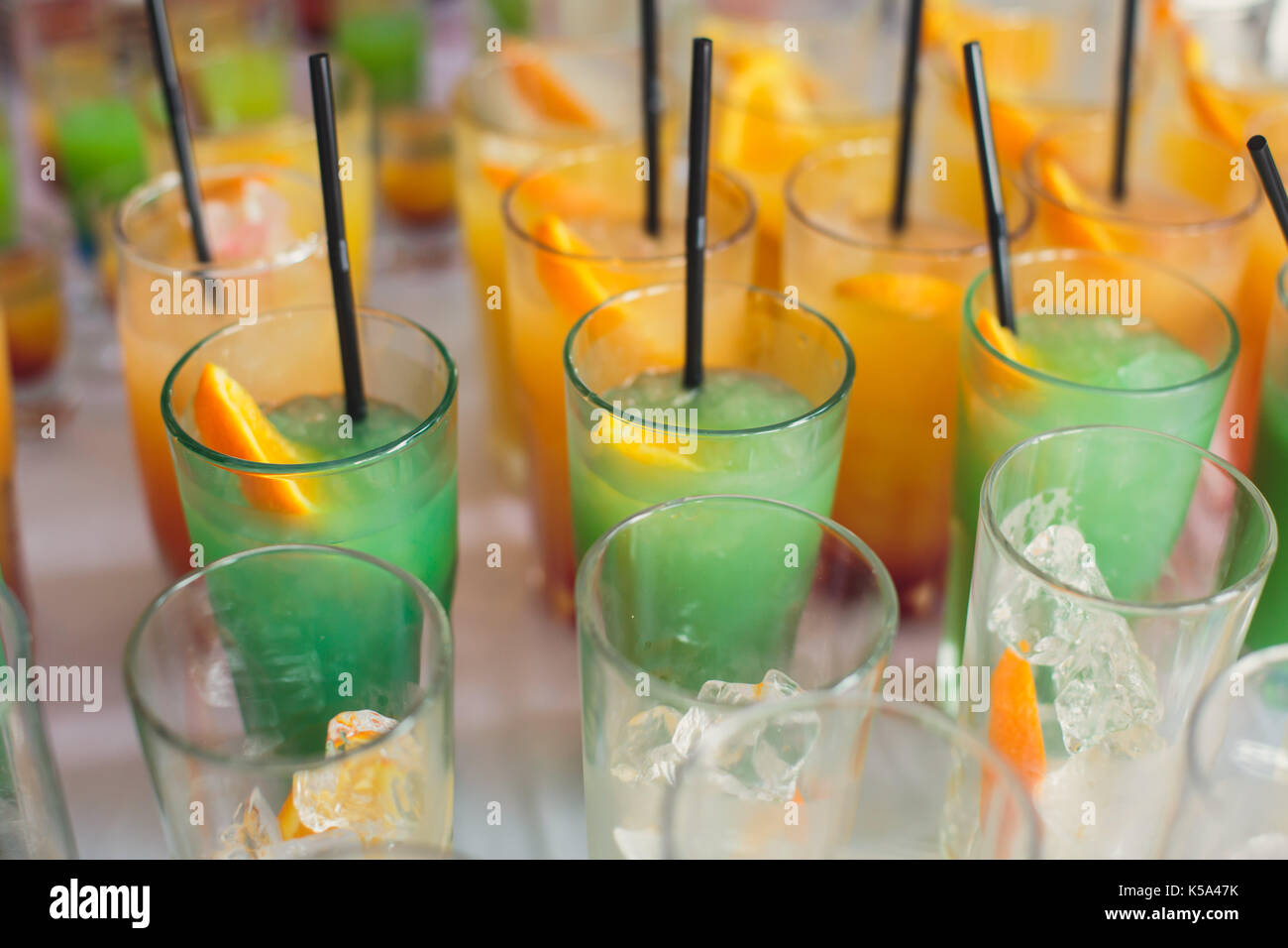 Beautiful line of different coloured cocktails on a open air party ...