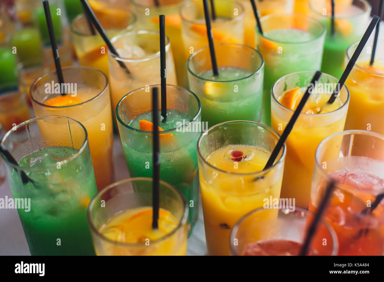 Beautiful line of different coloured cocktails on a open air party ...