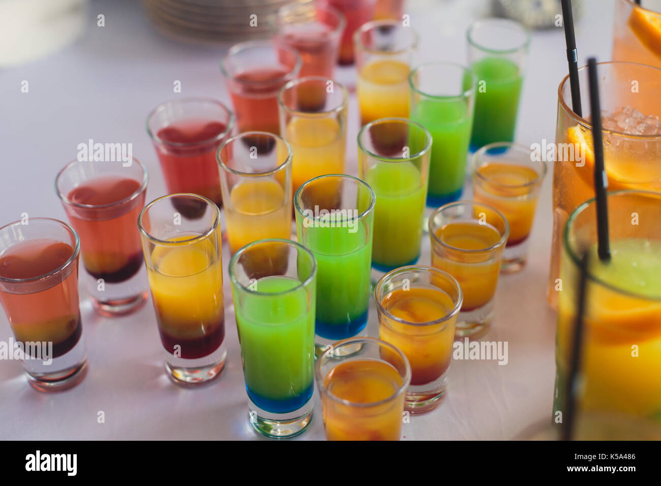 Beautiful line of different coloured cocktails on a open air party ...