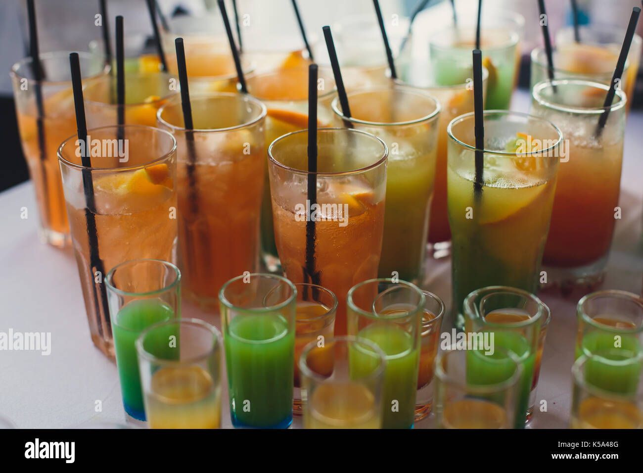 Beautiful line of different coloured cocktails on a open air party ...