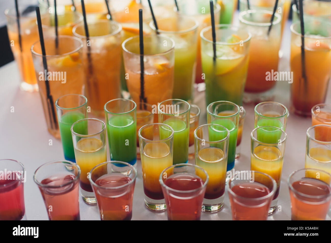 Beautiful line of different coloured cocktails on a open air party ...