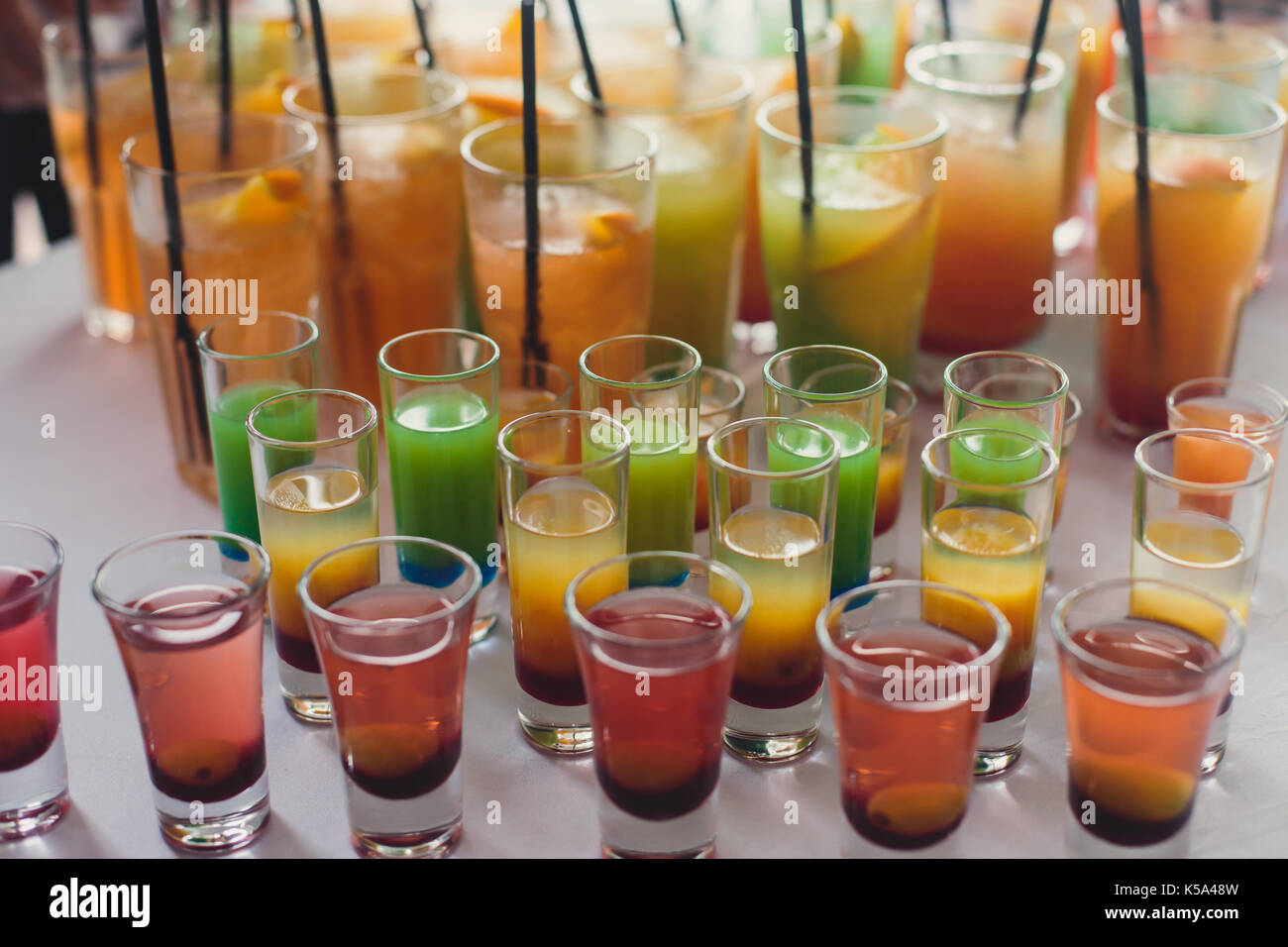 Beautiful line of different coloured cocktails on a open air party ...