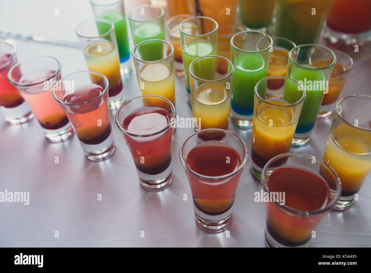 Beautiful line of different coloured cocktails on a open air party ...
