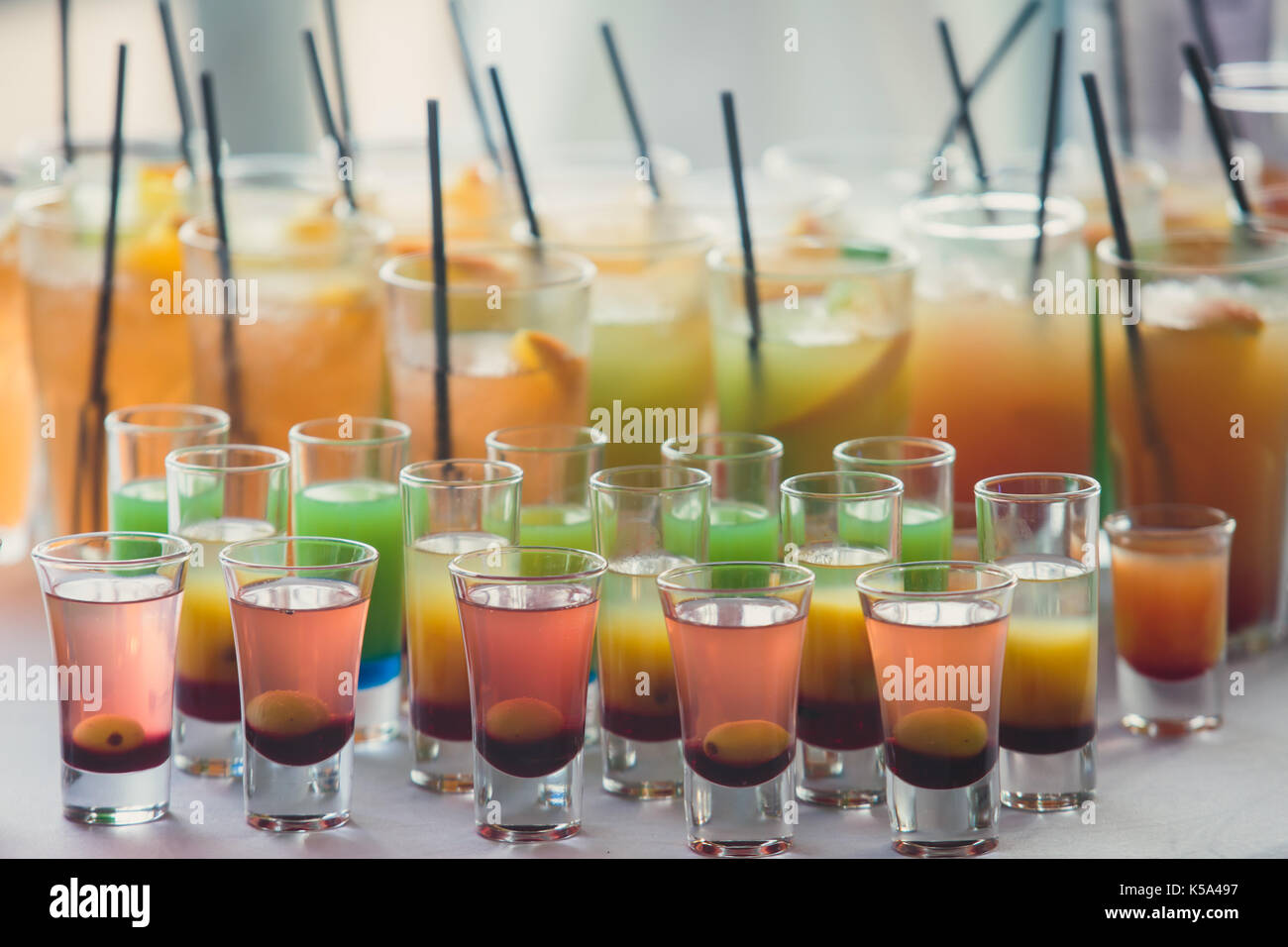 Beautiful line of different coloured cocktails on a open air party ...