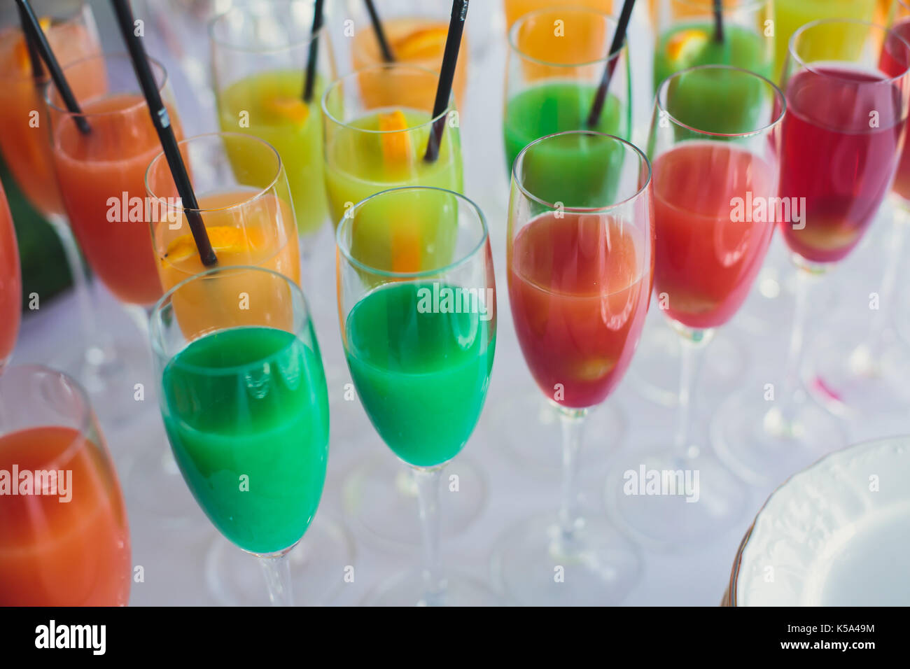 Beautiful line of different coloured cocktails on a open air party ...