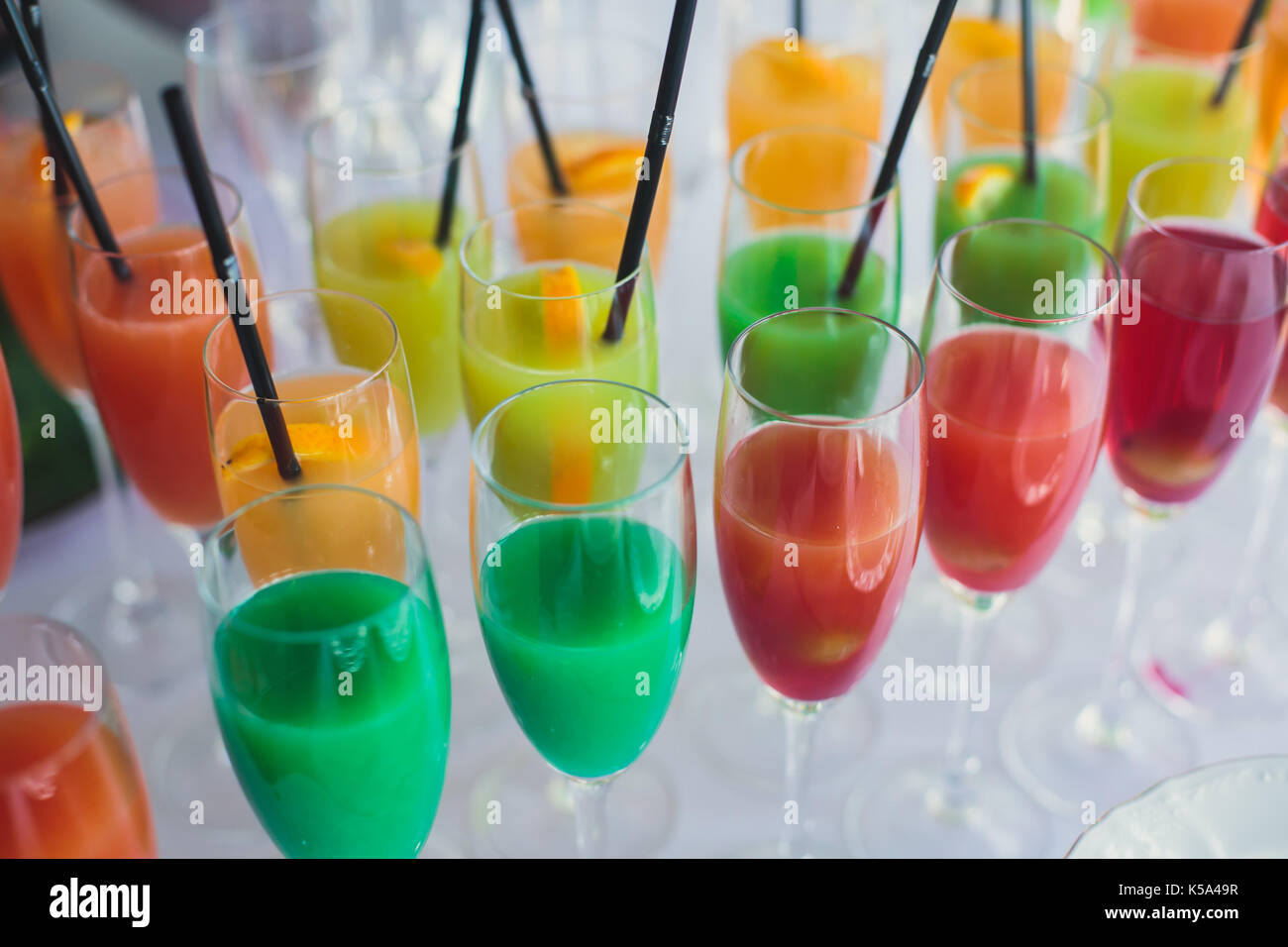 Beautiful line of different coloured cocktails on a open air party ...