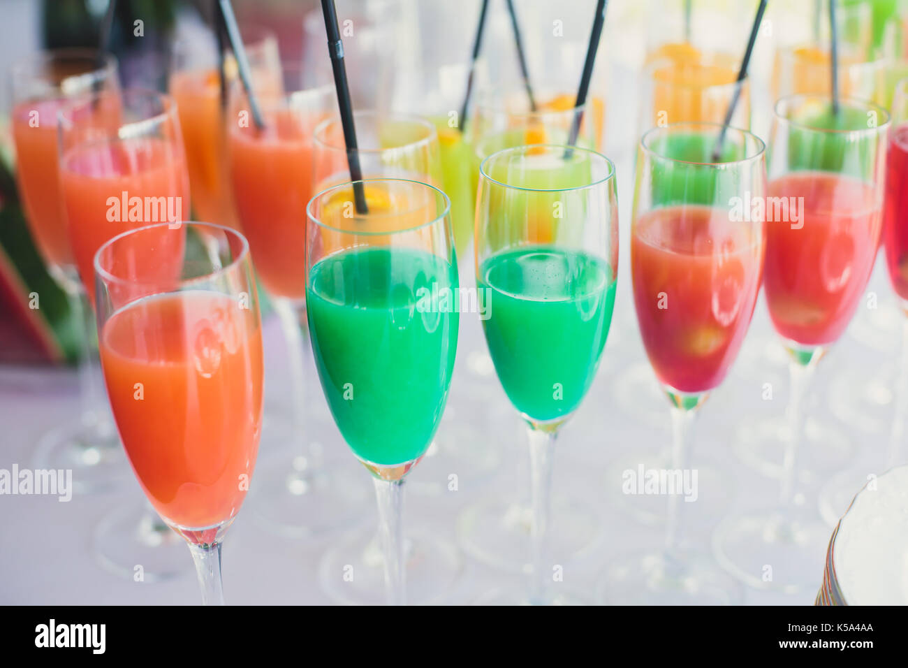Beautiful line of different coloured cocktails on a open air party ...