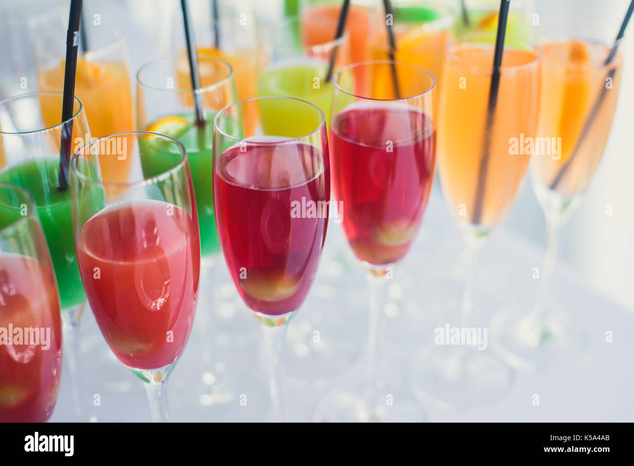 Beautiful line of different coloured cocktails on a open air party ...
