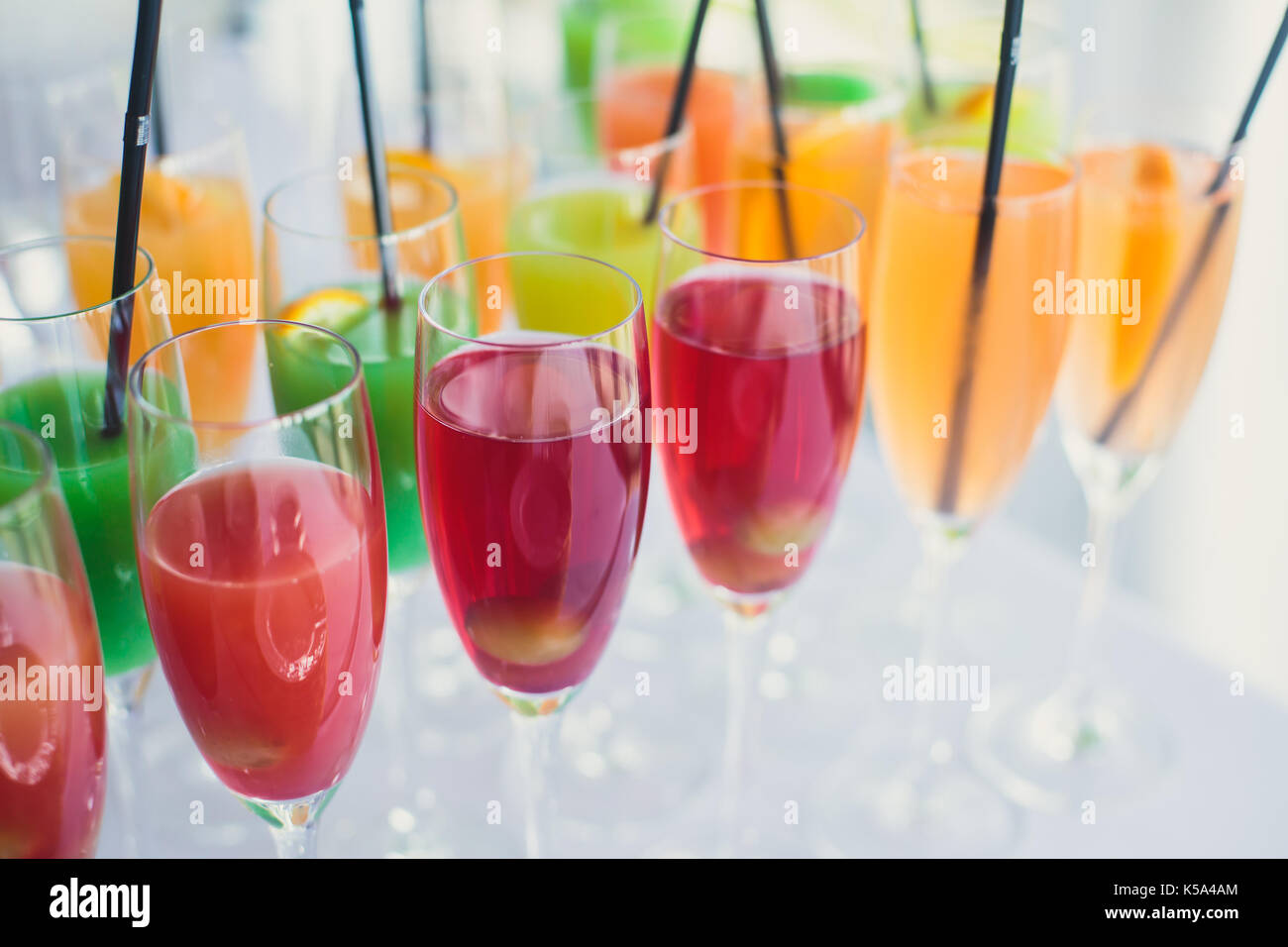 Beautiful line of different coloured cocktails on a open air party ...