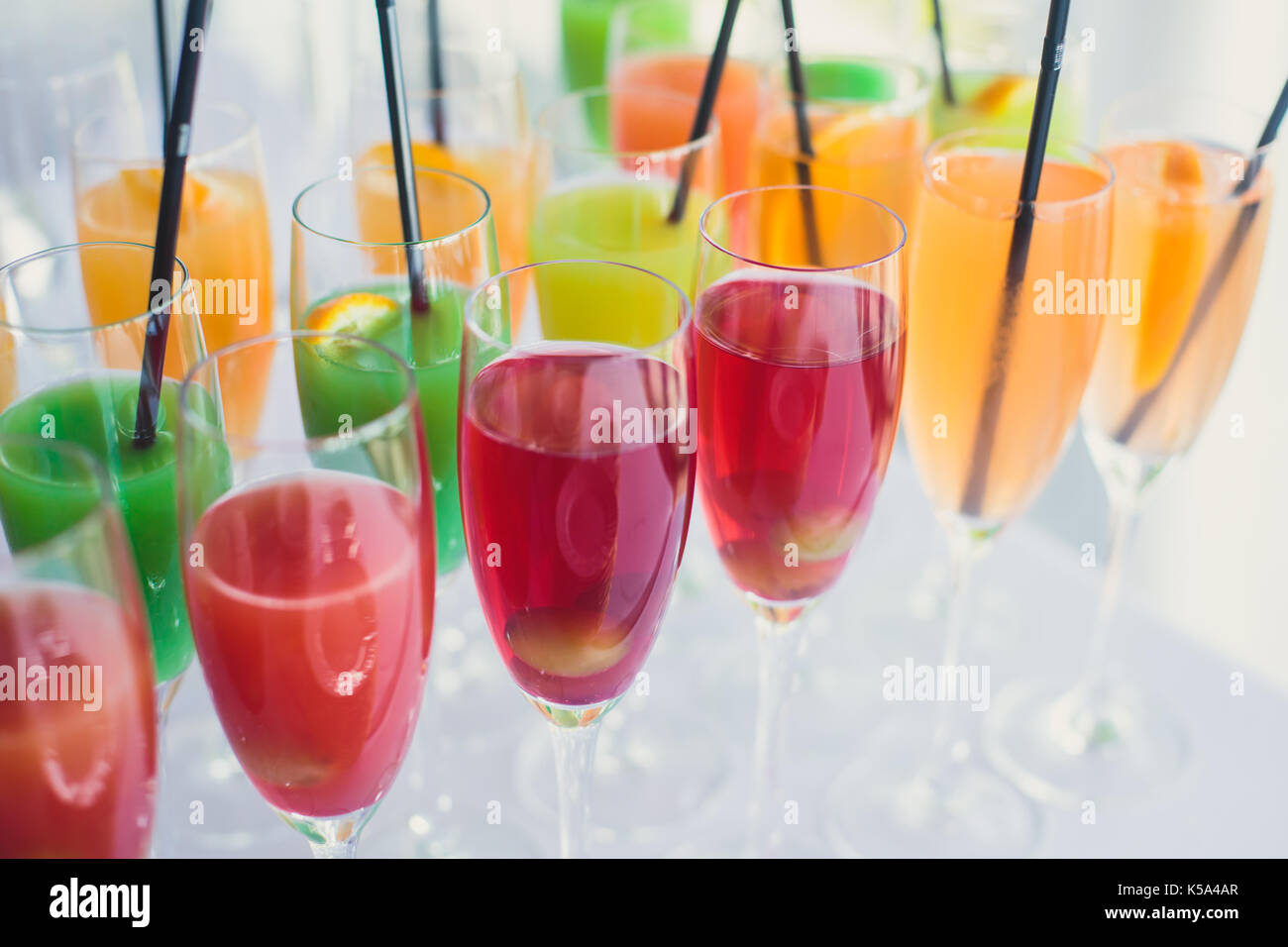 Beautiful line of different coloured cocktails on a open air party ...
